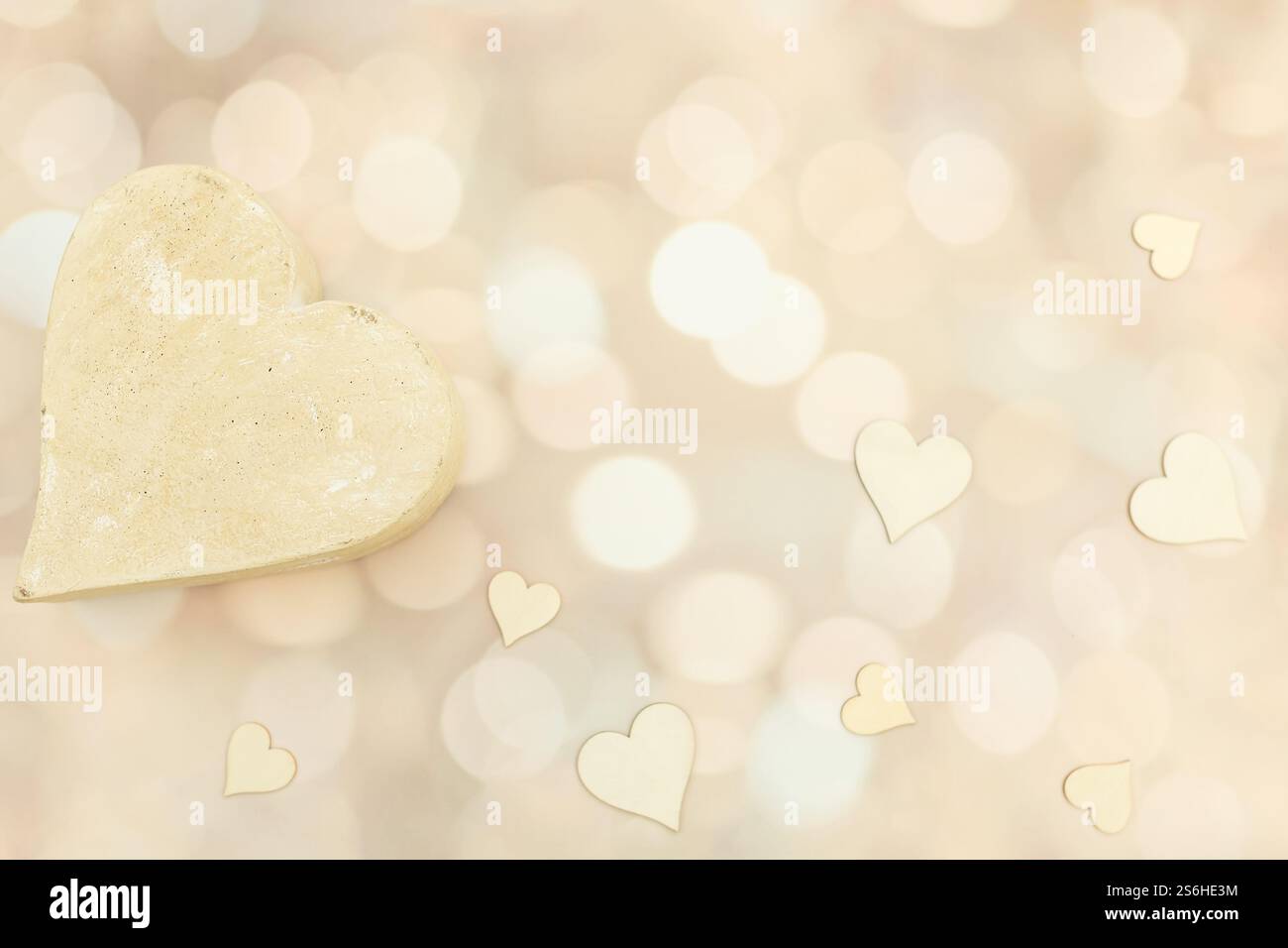 Overhead flat lay with neutral hearts on a white, cream, pink backdrop ...