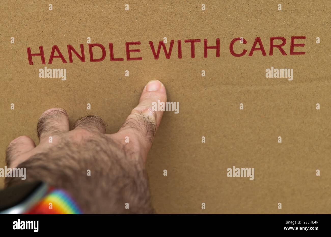 A close-up image showing the words handle with care printed in red on a ...