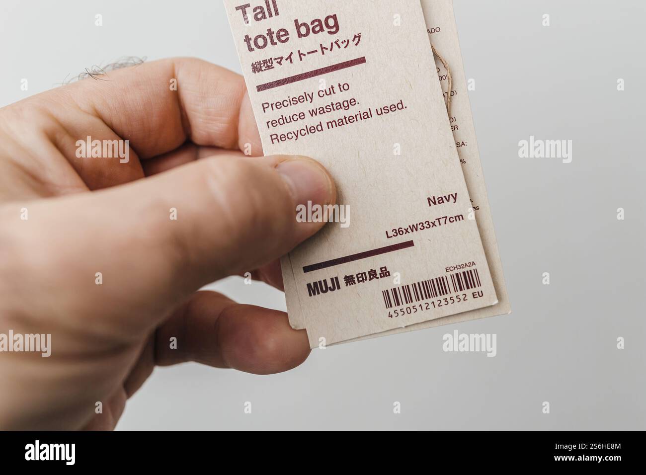 Paris, France - Oct 25, 2023: A close-up of a hand holding a MUJI tall ...