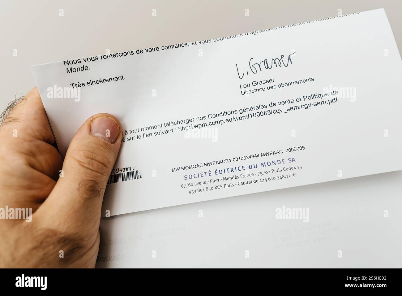 Paris, France - Oct 25, 2023: A hand holding a document featuring a ...