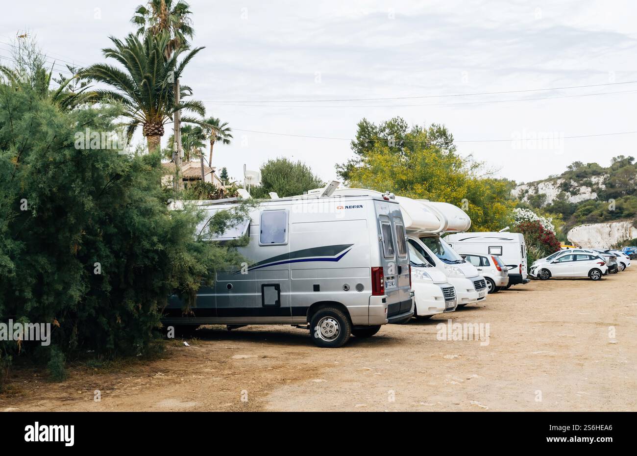 Cala Romantica, Spain - Jul 6, 2024: A lineup of camper vans and cars ...