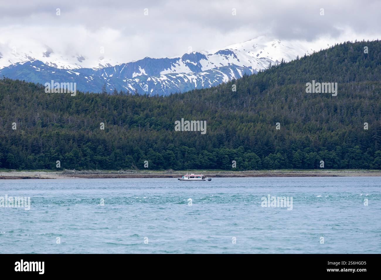 Tour boat cruising along the Alaskan coast Stock Photo - Alamy
