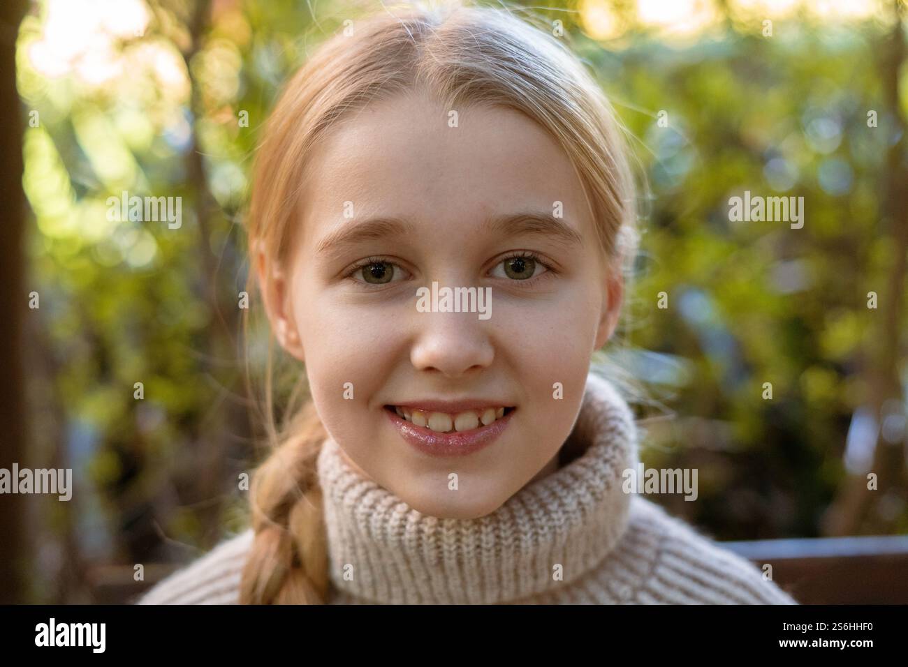 Portrait of smiling blonde preteen girl wearing knitted sweater Stock ...