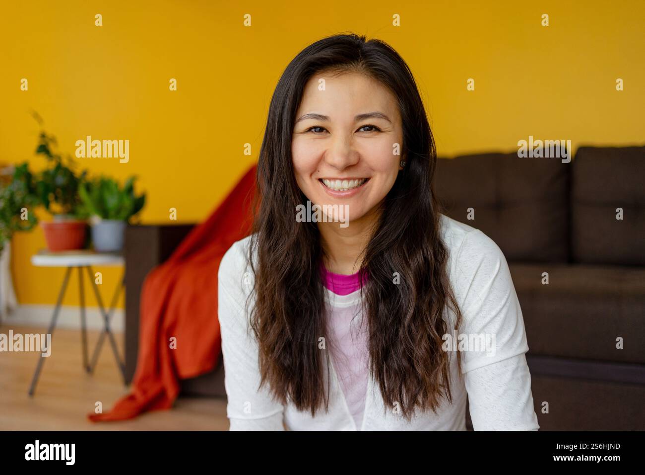 A pretty young Latina woman laughing at the camera at home Stock Photo ...