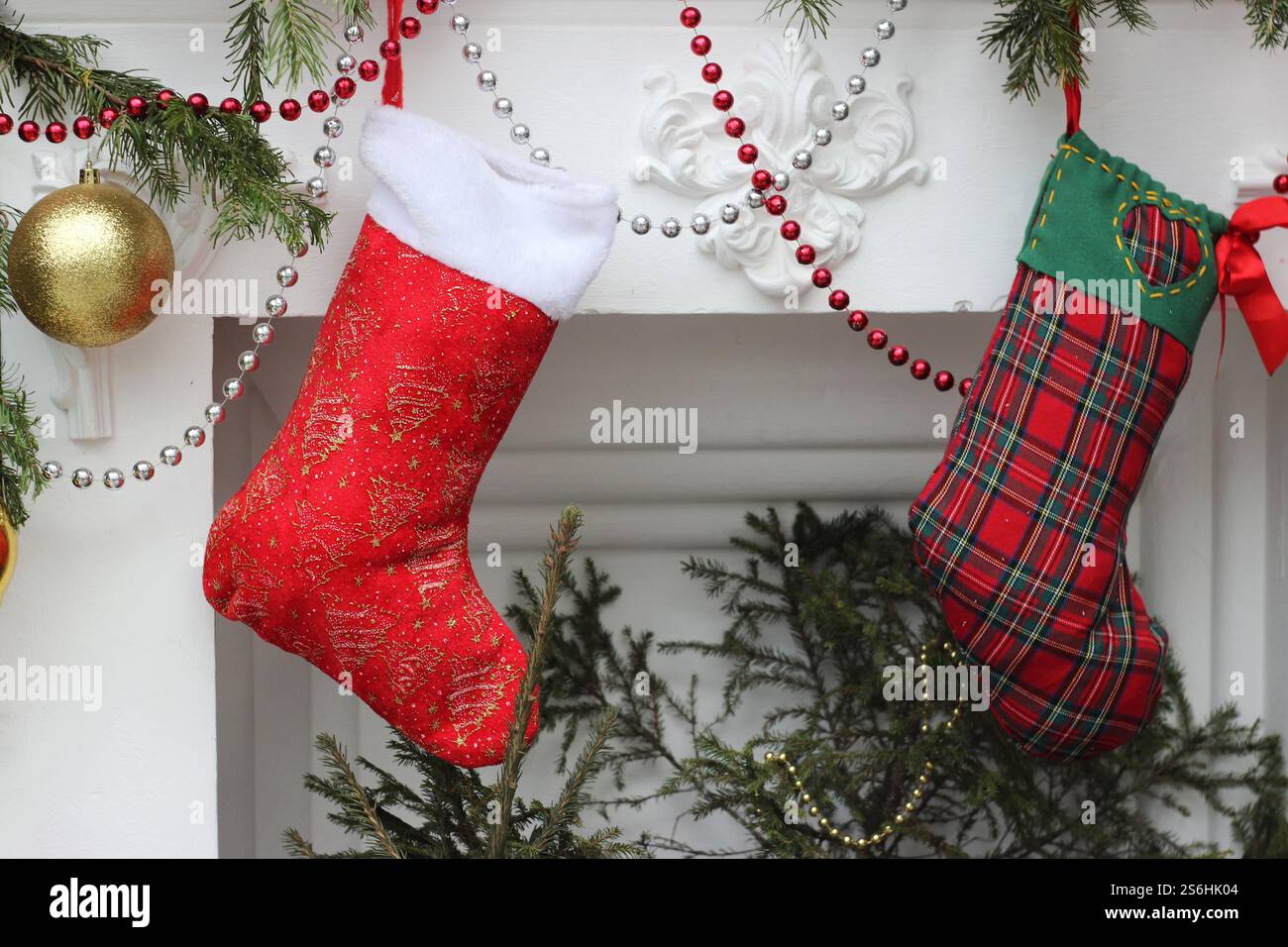 Christmas stockings hang above a decorative fireplace Stock Photo - Alamy