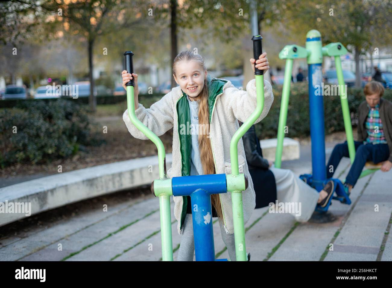 blonde girl with long hair exercising on an elliptical machine Stock ...