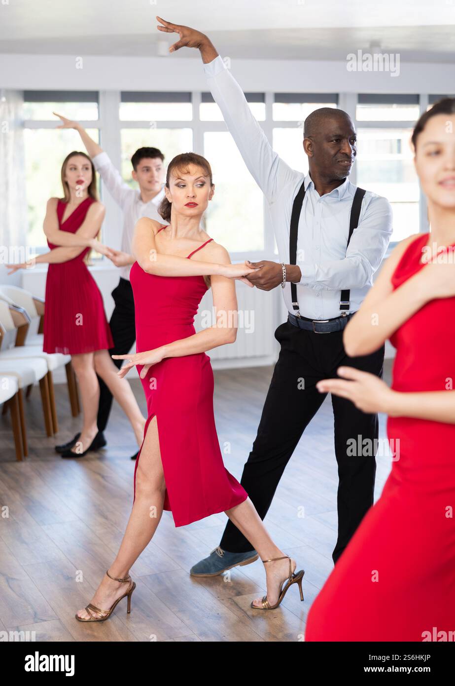 Smiling young woman and African american partner successfully perform ...