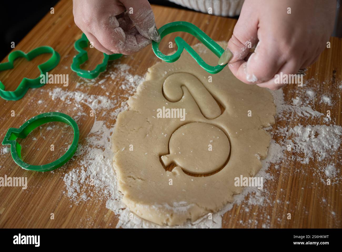 Cutting festive shapes in cookie dough Stock Photo - Alamy