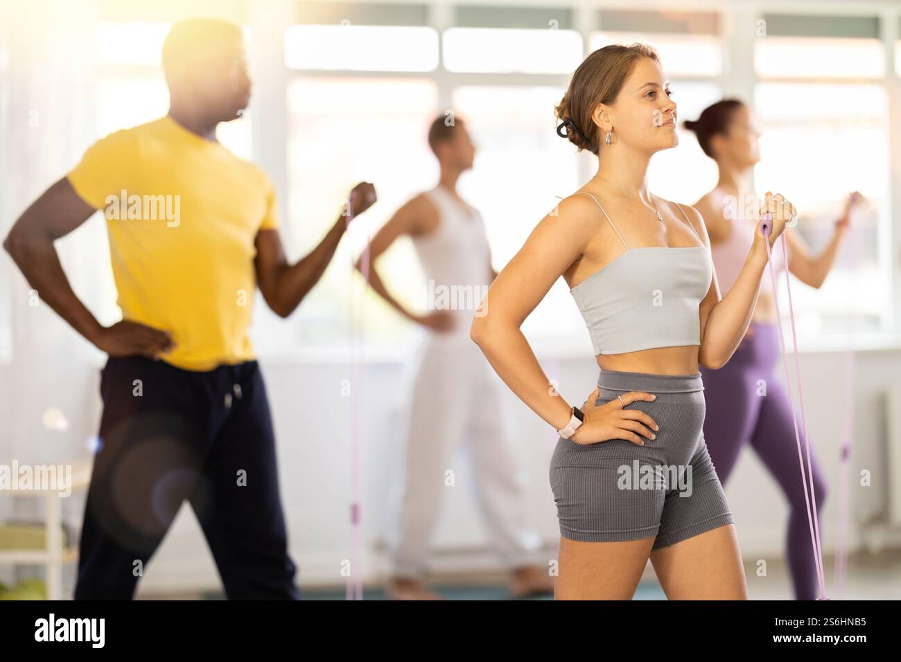 Girl exercising with figure eight band during group fitness class Stock ...