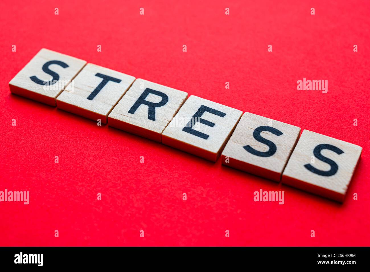 Word Stress, composed with wooden alphabet blocks, on red surface Stock ...