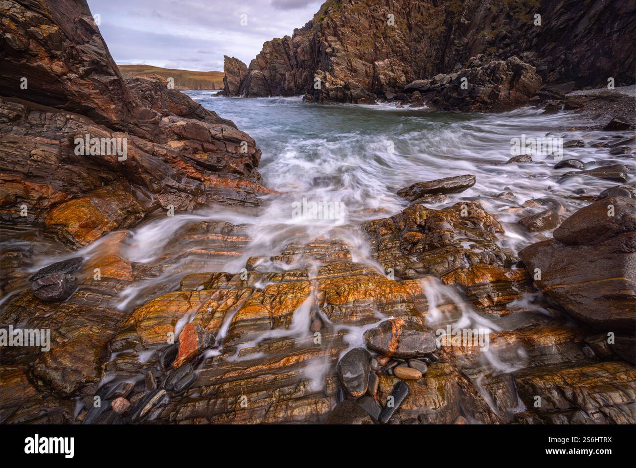 Waves rush in over the beautiful rocks in an inlet at Ard beag from ...