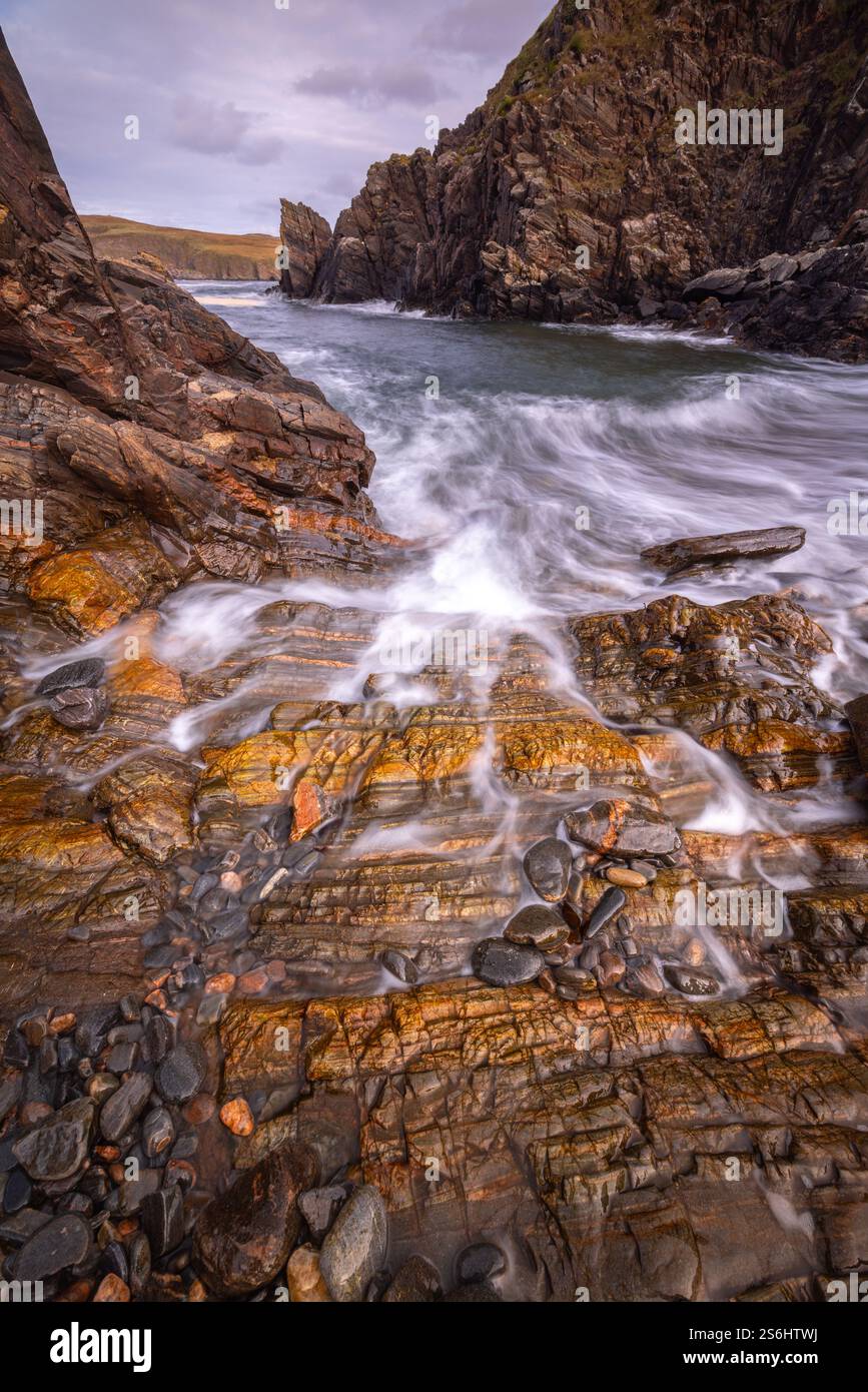 Waves rush in over the beautiful rocks in an inlet at Ard beag from ...