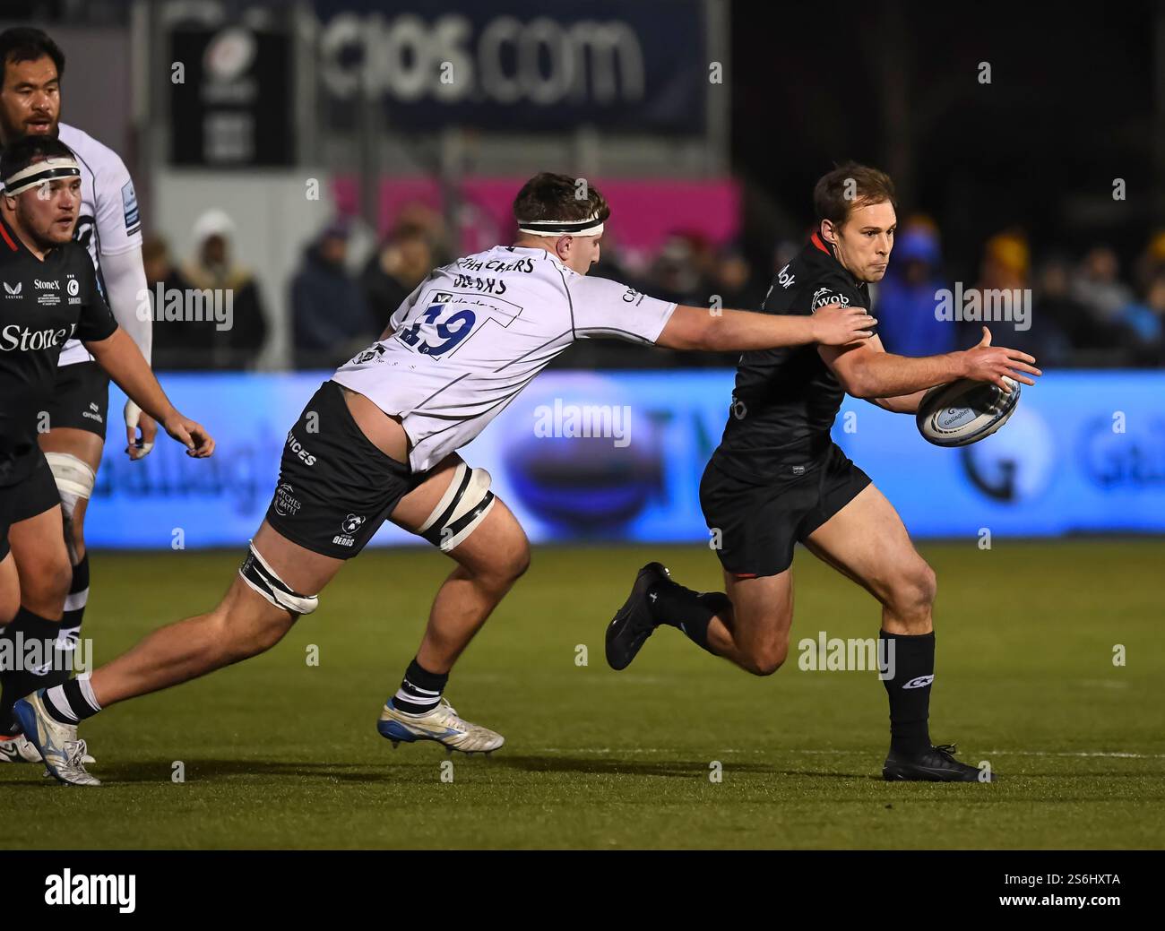 Ivan van Zyl of Saracens and Steele Barker of Bristol Bears in action ...
