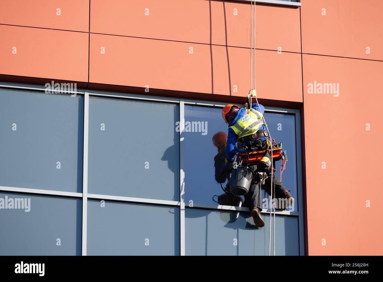 Window cleaner on Hilton Garden Inn hotel, Birmingham Airport, UK Stock ...