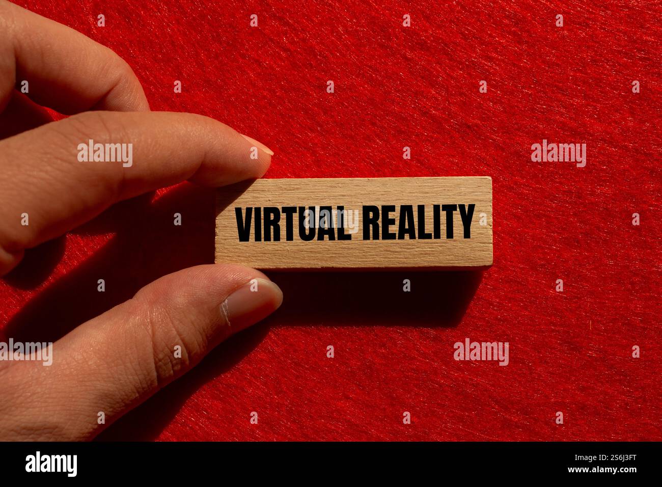 Virtual reality message written on wooden block with red background ...