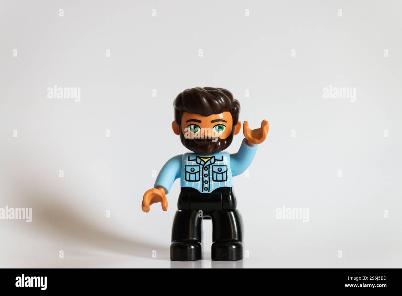 A Duplo person with their hand in the air Stock Photo - Alamy