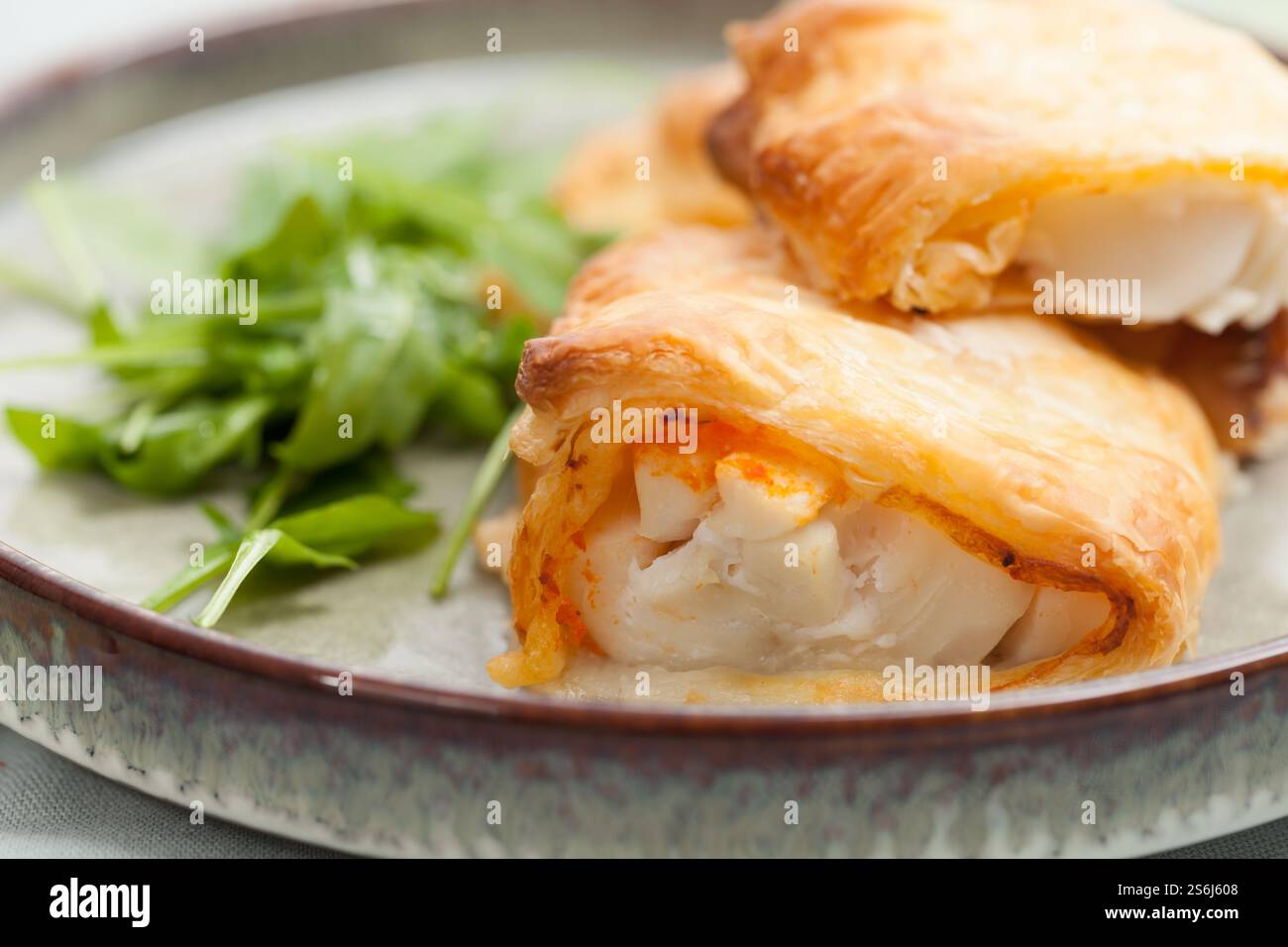 Baked cod in puff pastry Stock Photo - Alamy