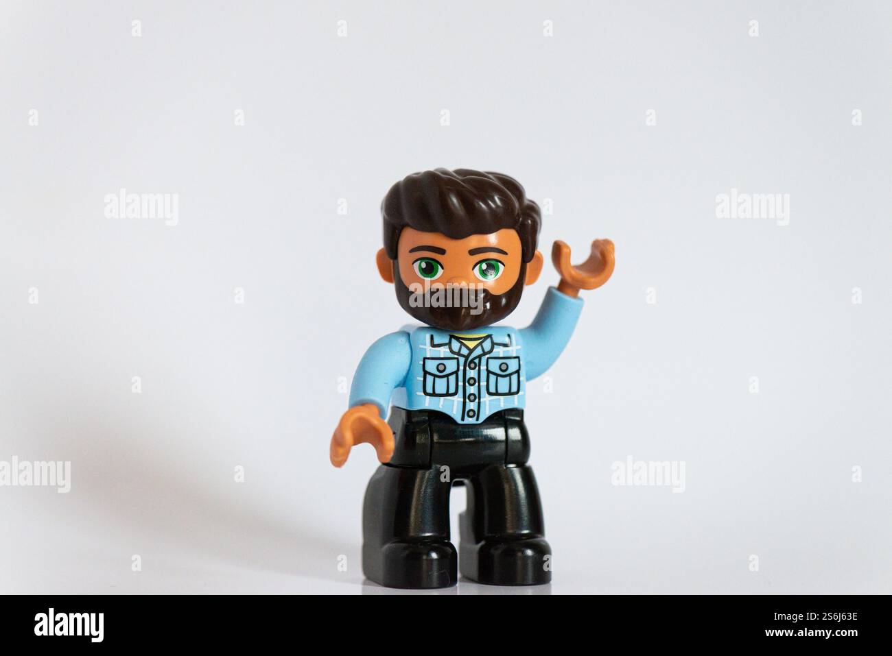 A Duplo person with their hand in the air Stock Photo - Alamy