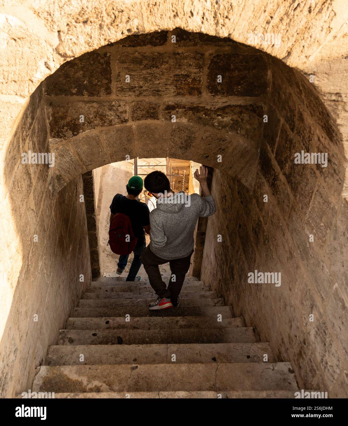 Tourists visiting Torres de Serranos (Serranos Gate) with late evening ...