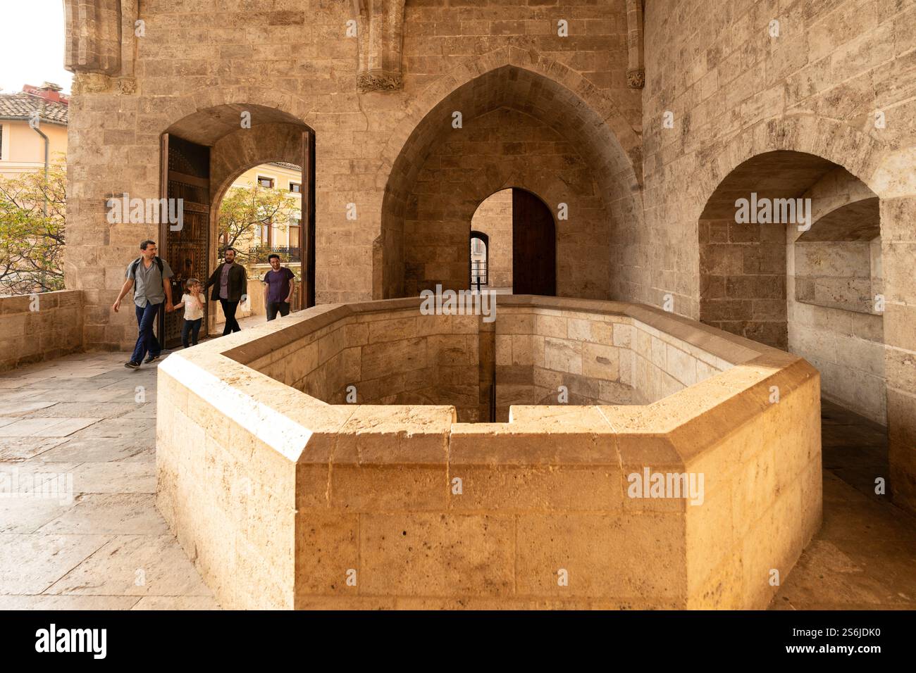 Tourists visiting Torres de Serranos (Serranos Gate) with late evening ...