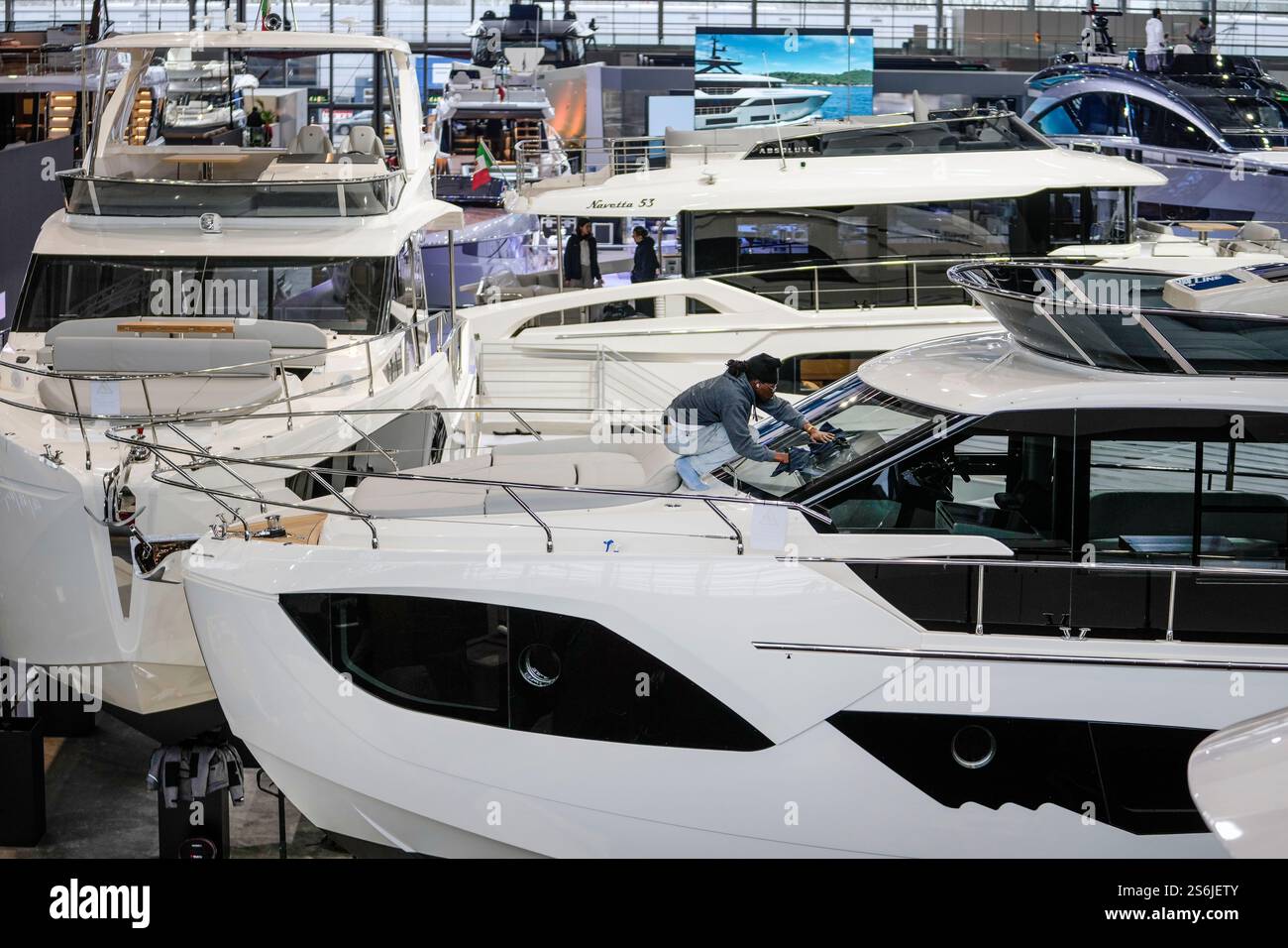 A worker cleans a super yacht at the water sports and boat show "boot ...
