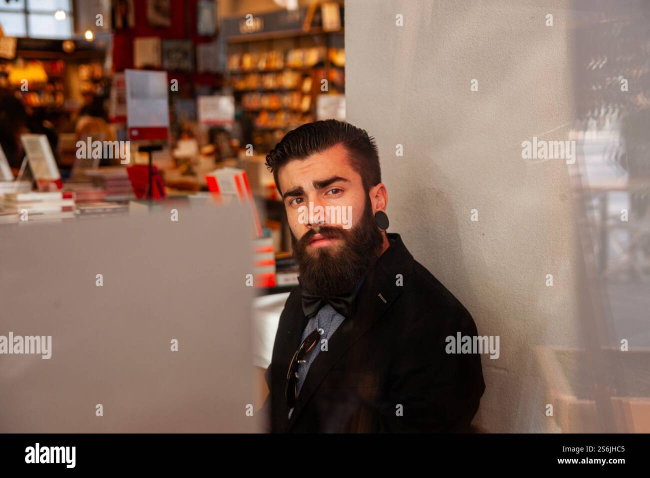young businessman taking a break in a cafe - view through shop young ...