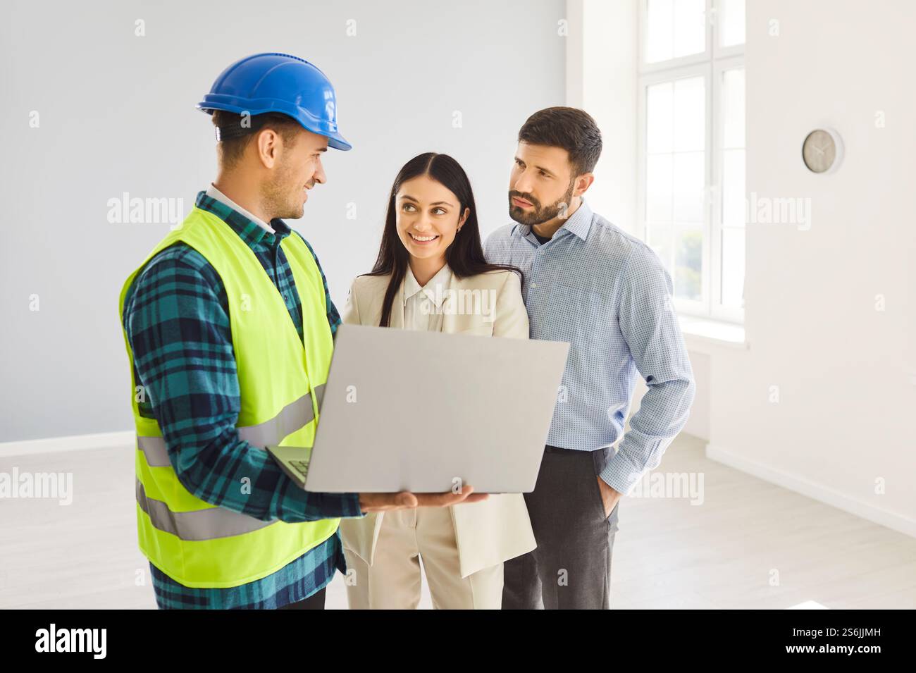 Family Couple Reviewing Home Renovation Blueprint With Contractor Stock ...