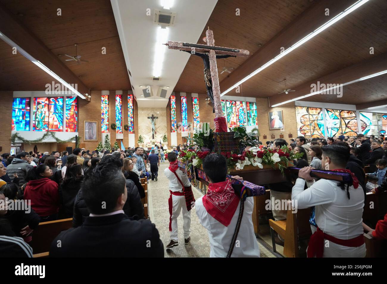 Church members carry a replica of the Black Christ of Esquipulas statue ...