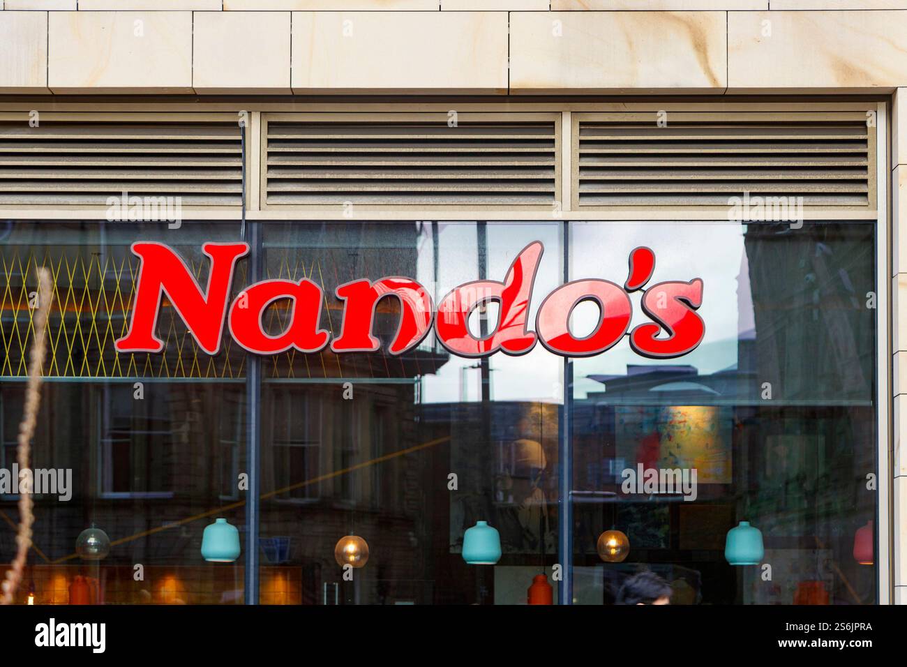 sign with red logo lettering for the restaurant chain Nandos in ...