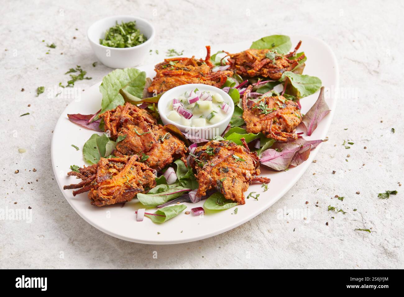 Carrot and Onion Pakoras with Raita Stock Photo - Alamy