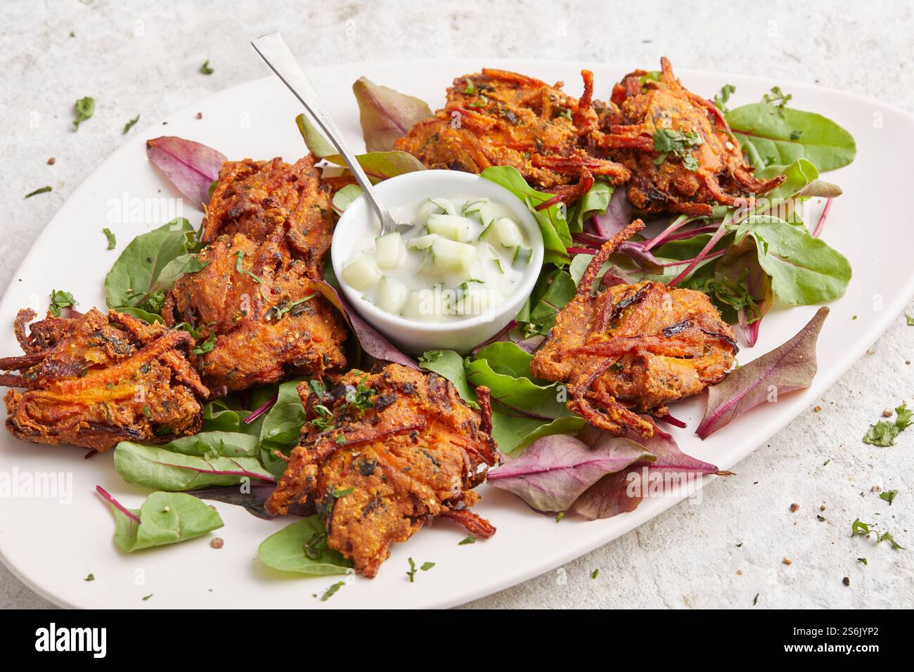 Carrot and Onion Pakoras with Raita Stock Photo - Alamy