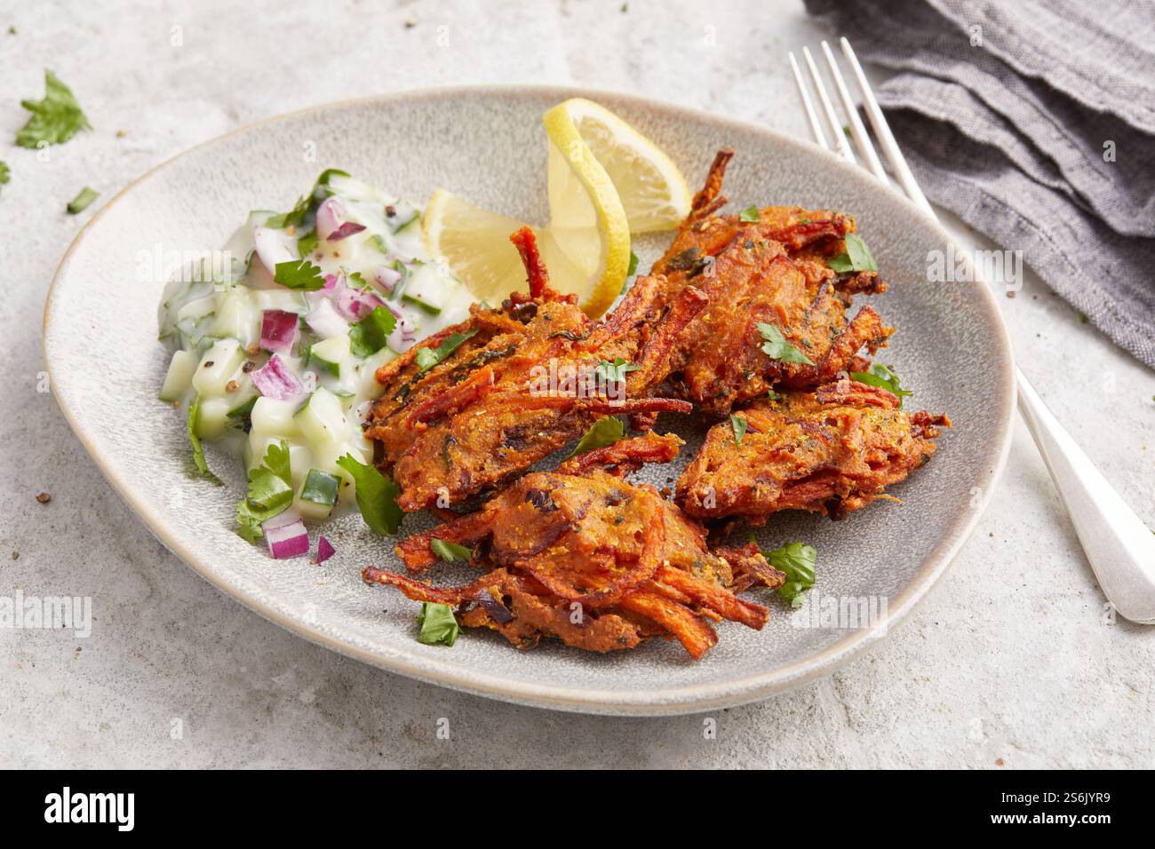 Carrot and Onion Pakoras with Raita Stock Photo - Alamy
