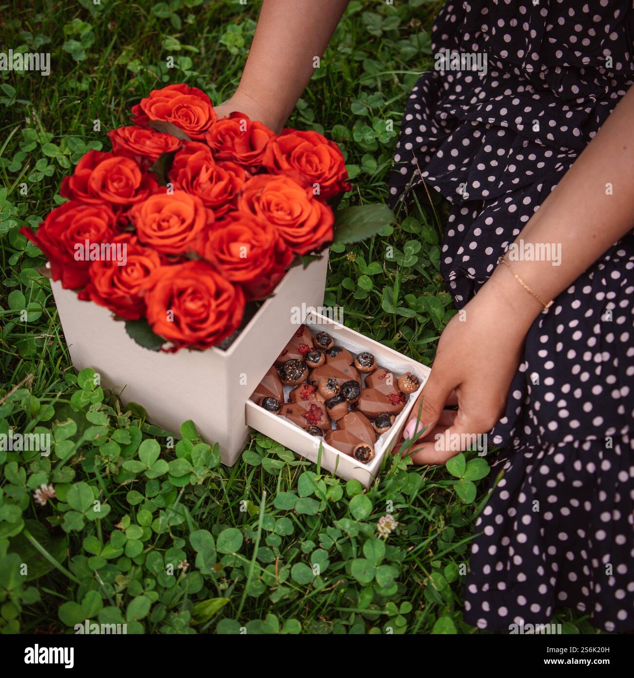 Gifts of Affection: Box of Flowers and Chocolate, Embraced by Hands and ...