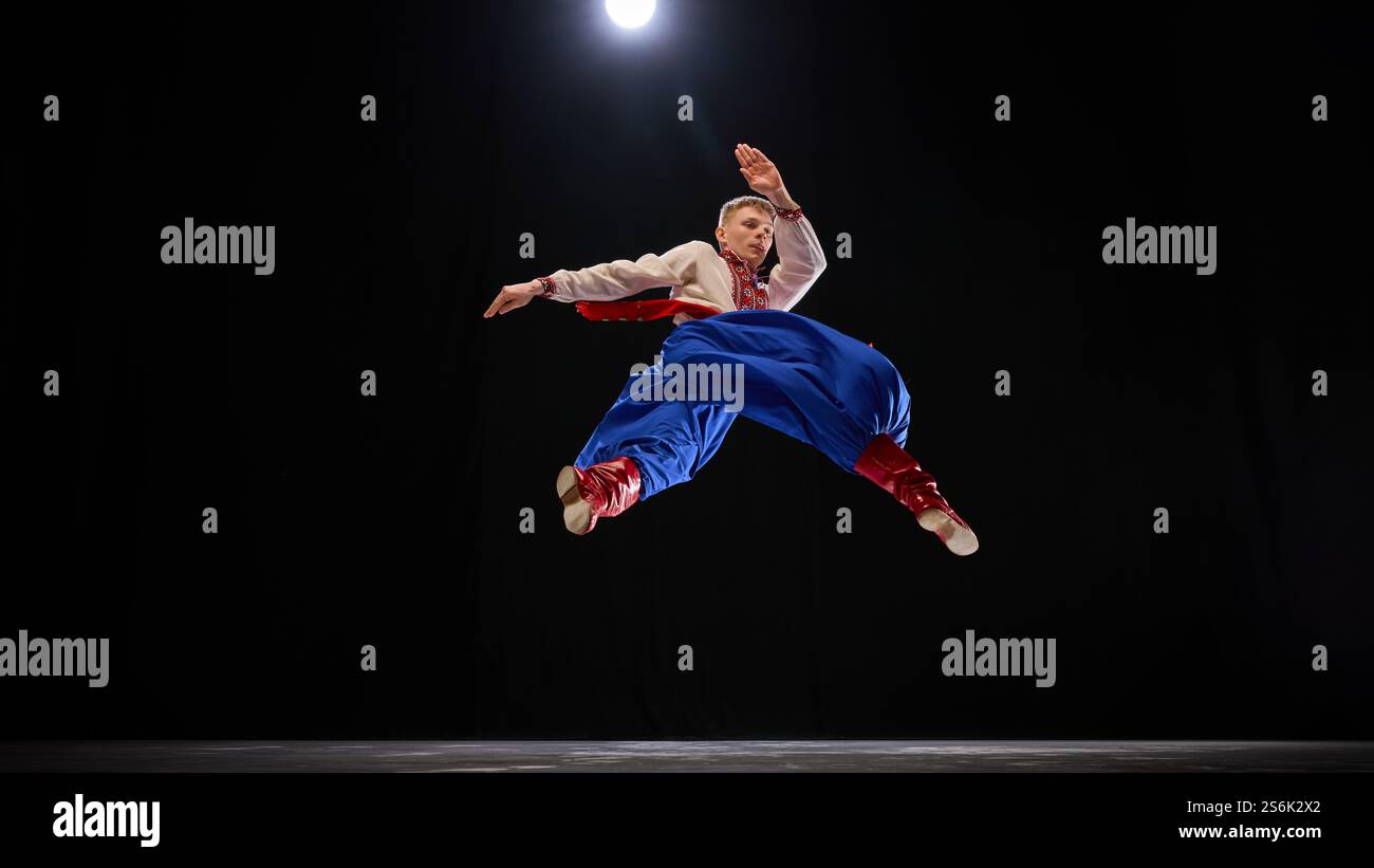 Male dancer flipping mid-air, body twisting with vibrant energy ...