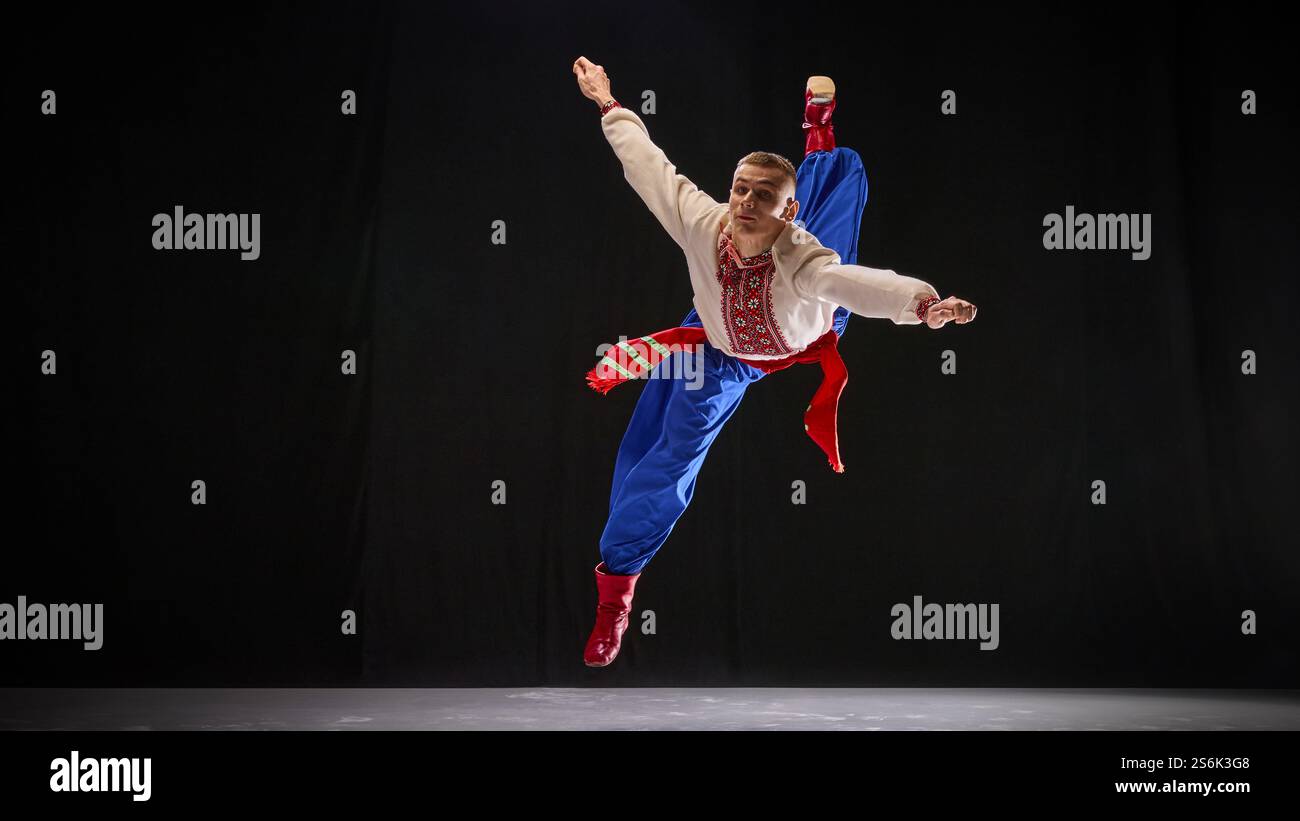 Male dancer in traditional Ukrainian attire, performing dance moves ...