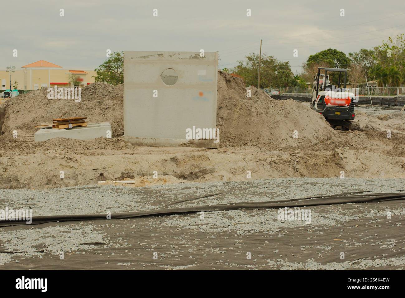 Construction site box concrete, black tarp,ditches piles of dirt and ...