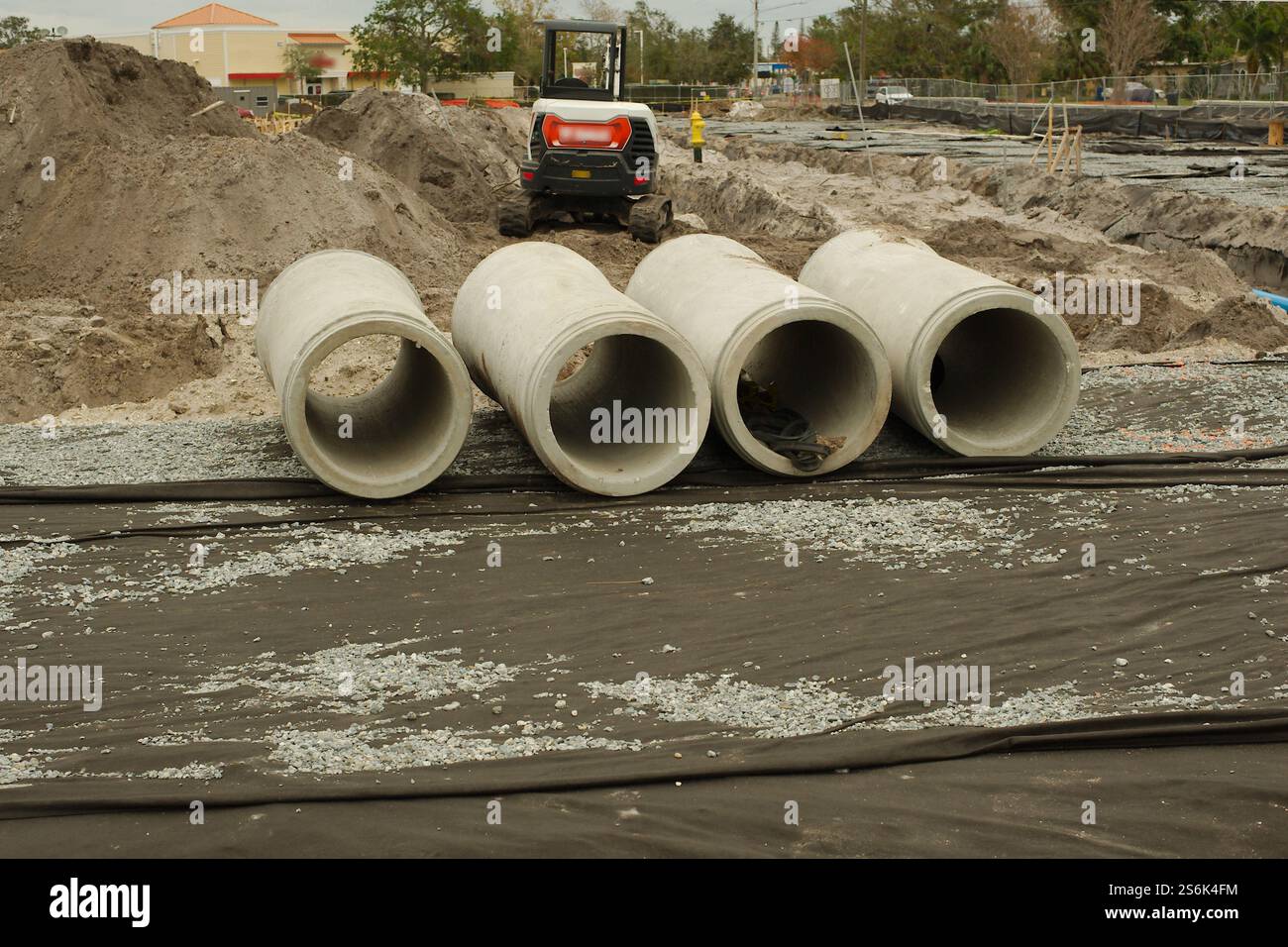 Construction site four concrete culverts, black tarp, yellow fire ...