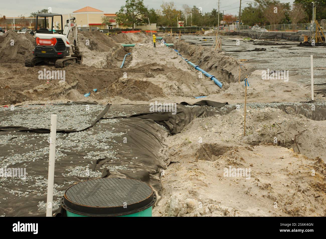 Construction site manhole cover, black tarp, yellow fire hydrant ...