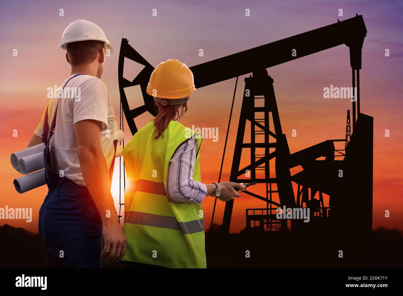 Workers at oil production site with crude oil pump Stock Photo - Alamy