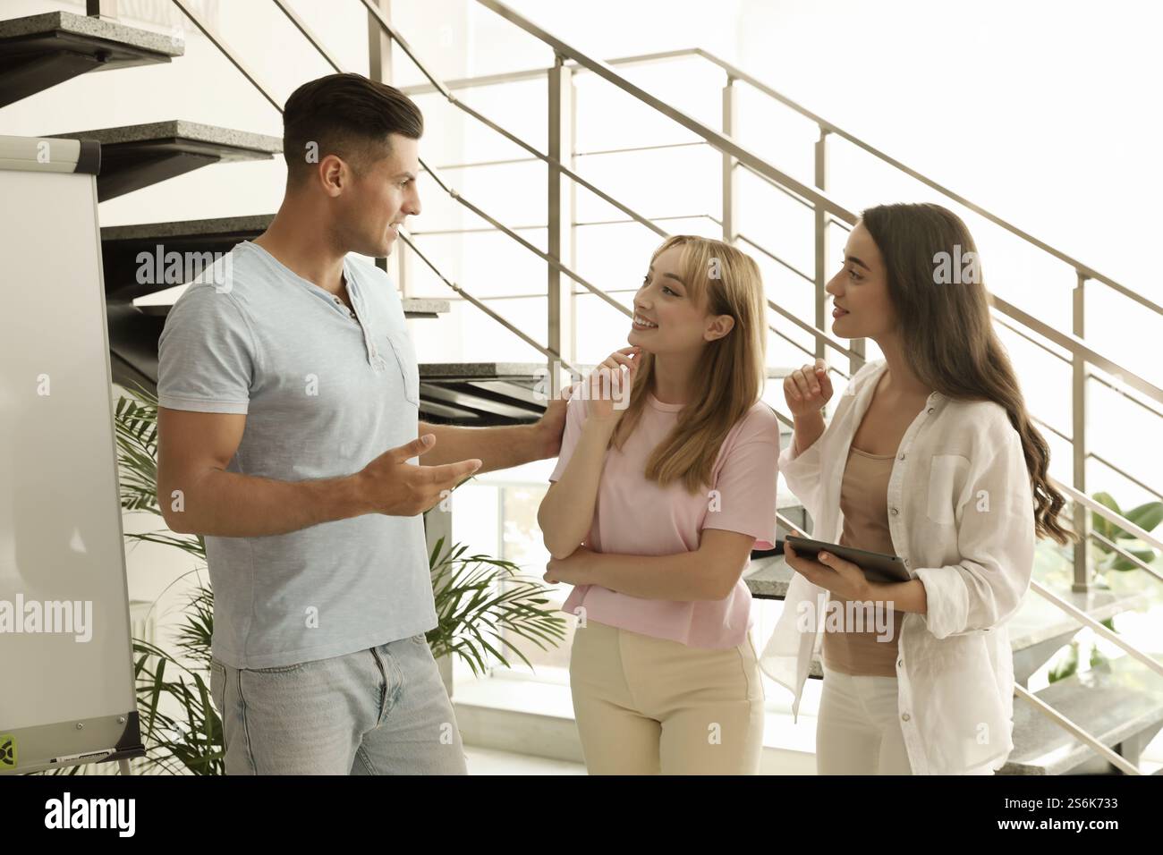 Group of people having conversation in hall Stock Photo - Alamy