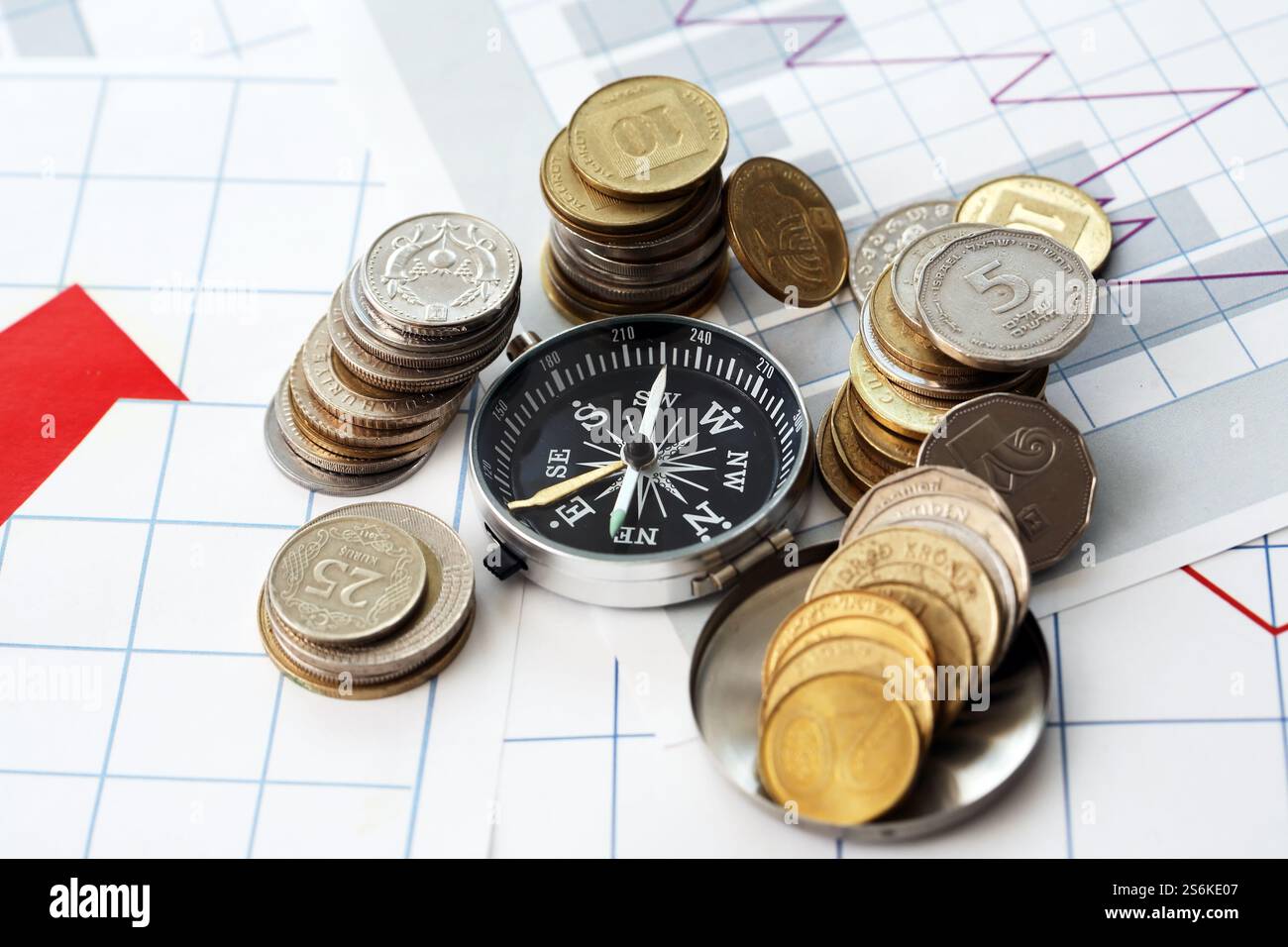 Business concept. Set of coins columns in a row and compass on diagram ...