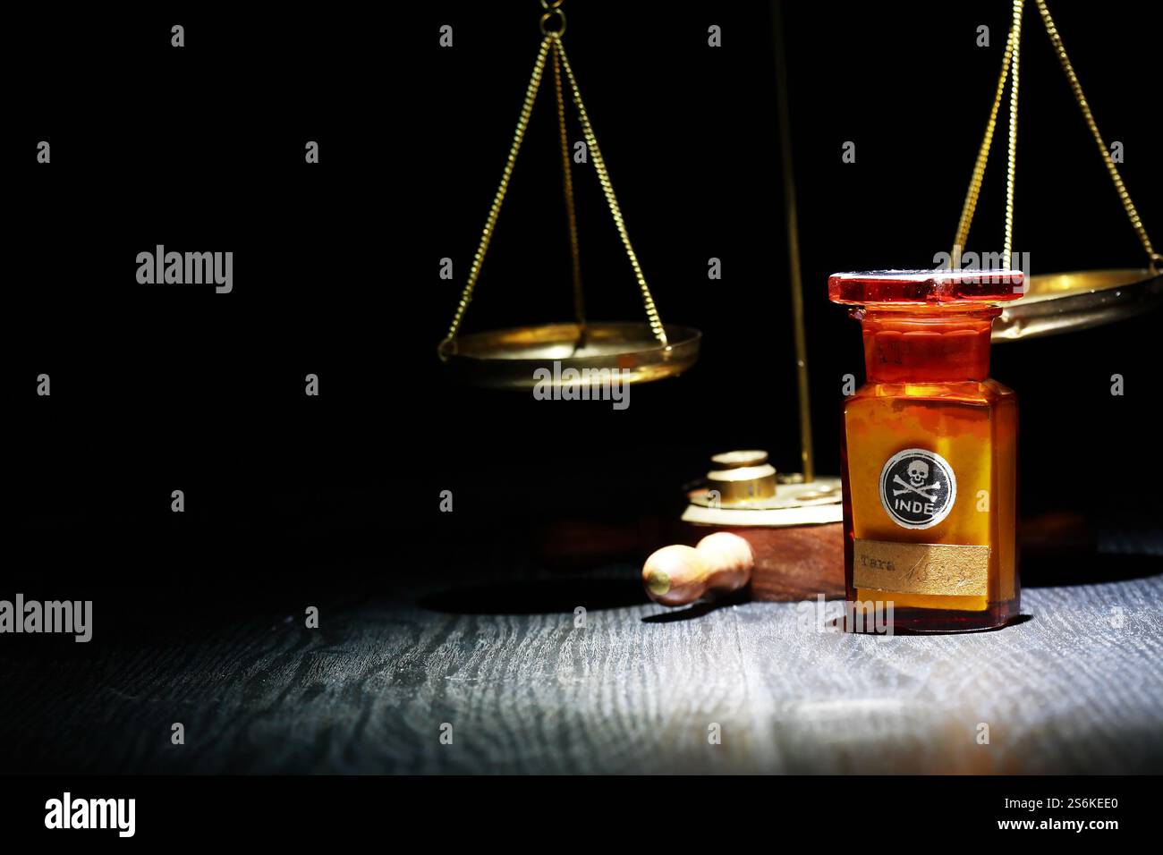 Old glass flask with poison under beam of light on dark background ...