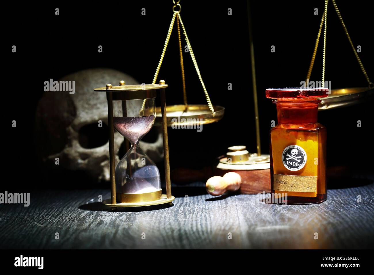 Old glass flask with poison under beam of light on dark background ...