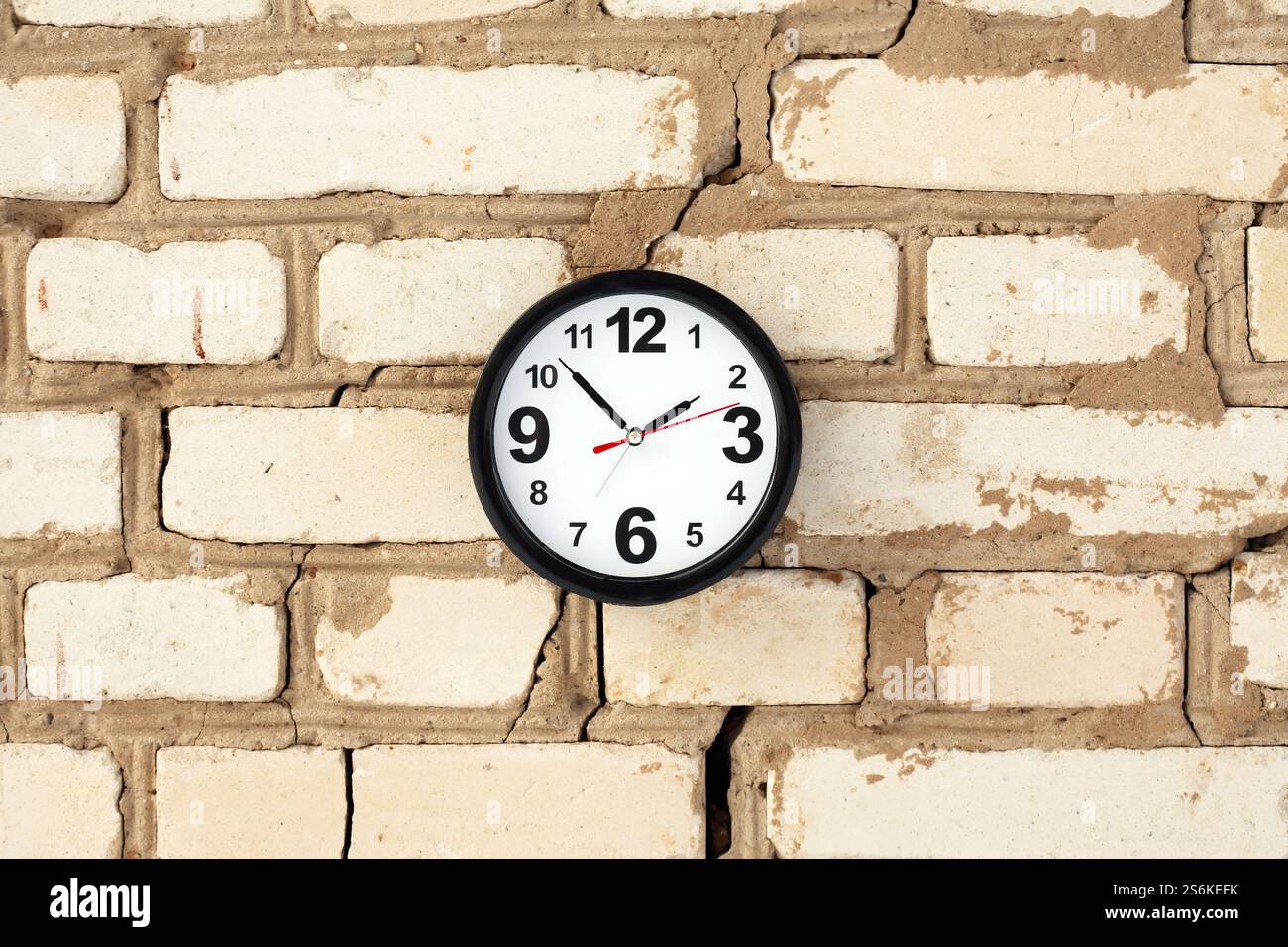 Clocks on a brick wall with free space Stock Photo - Alamy