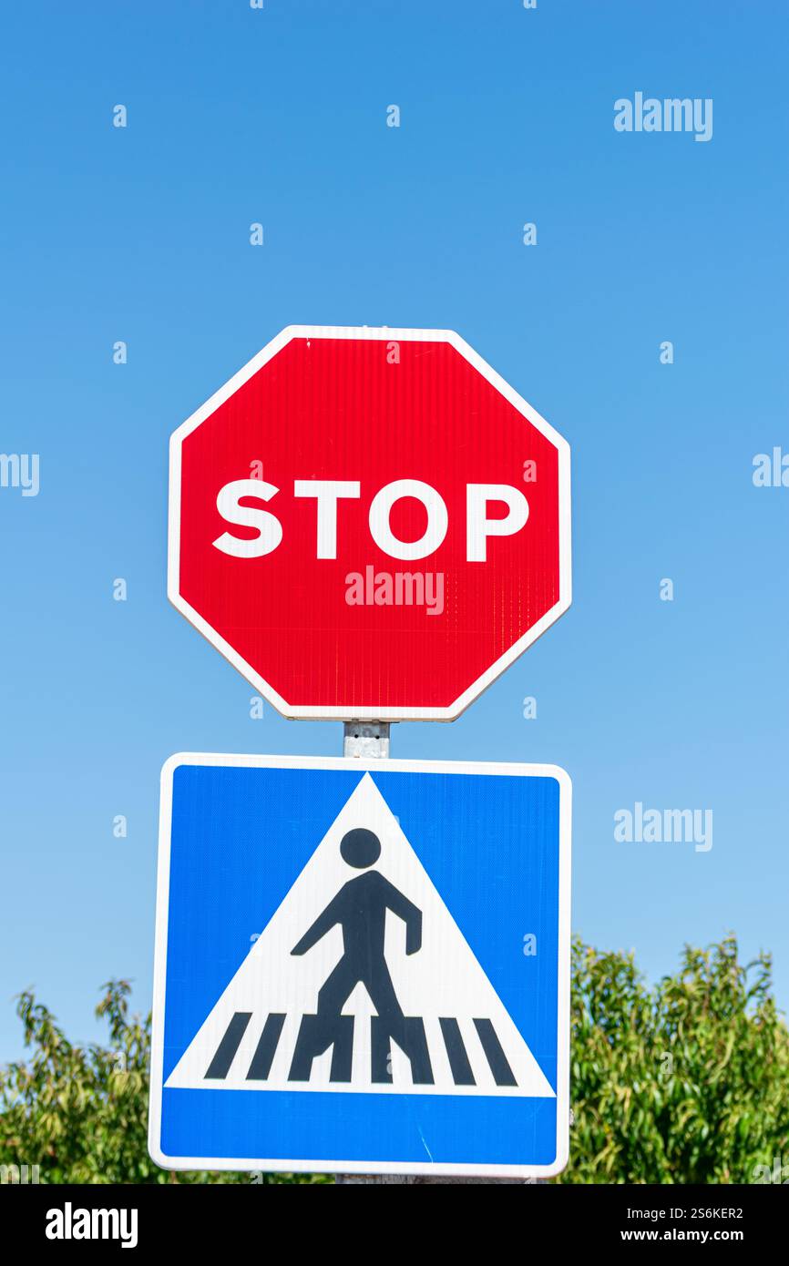 stop sign on a pedestrian crossing isolated against the blue sky ...