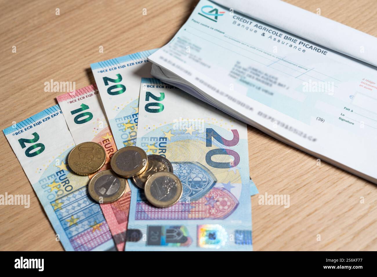 This photo is an illustration that shows Euro banknotes with coins and ...