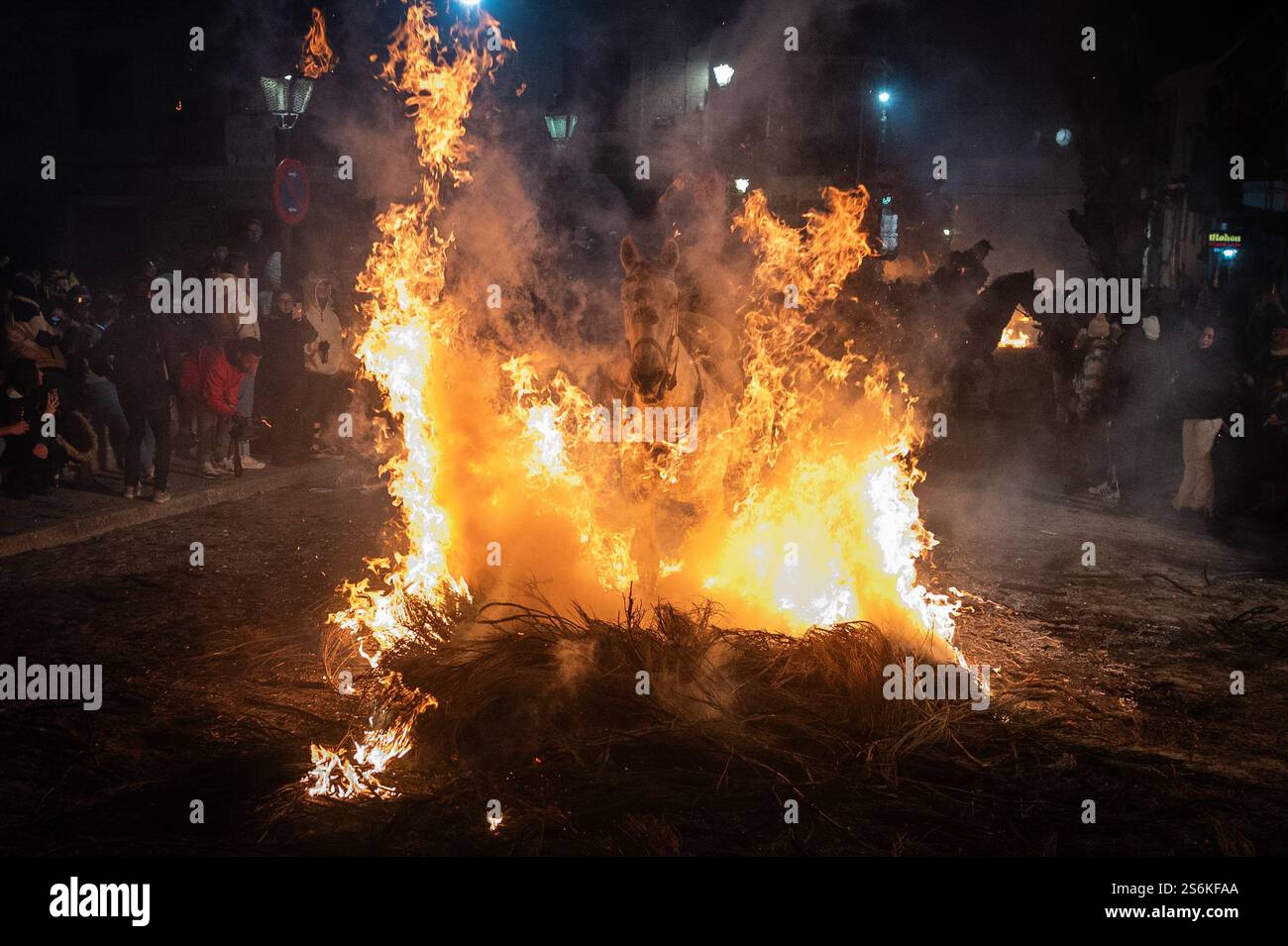 A horse rider jumps over a bonfire during "Las Luminarias" celebration ...