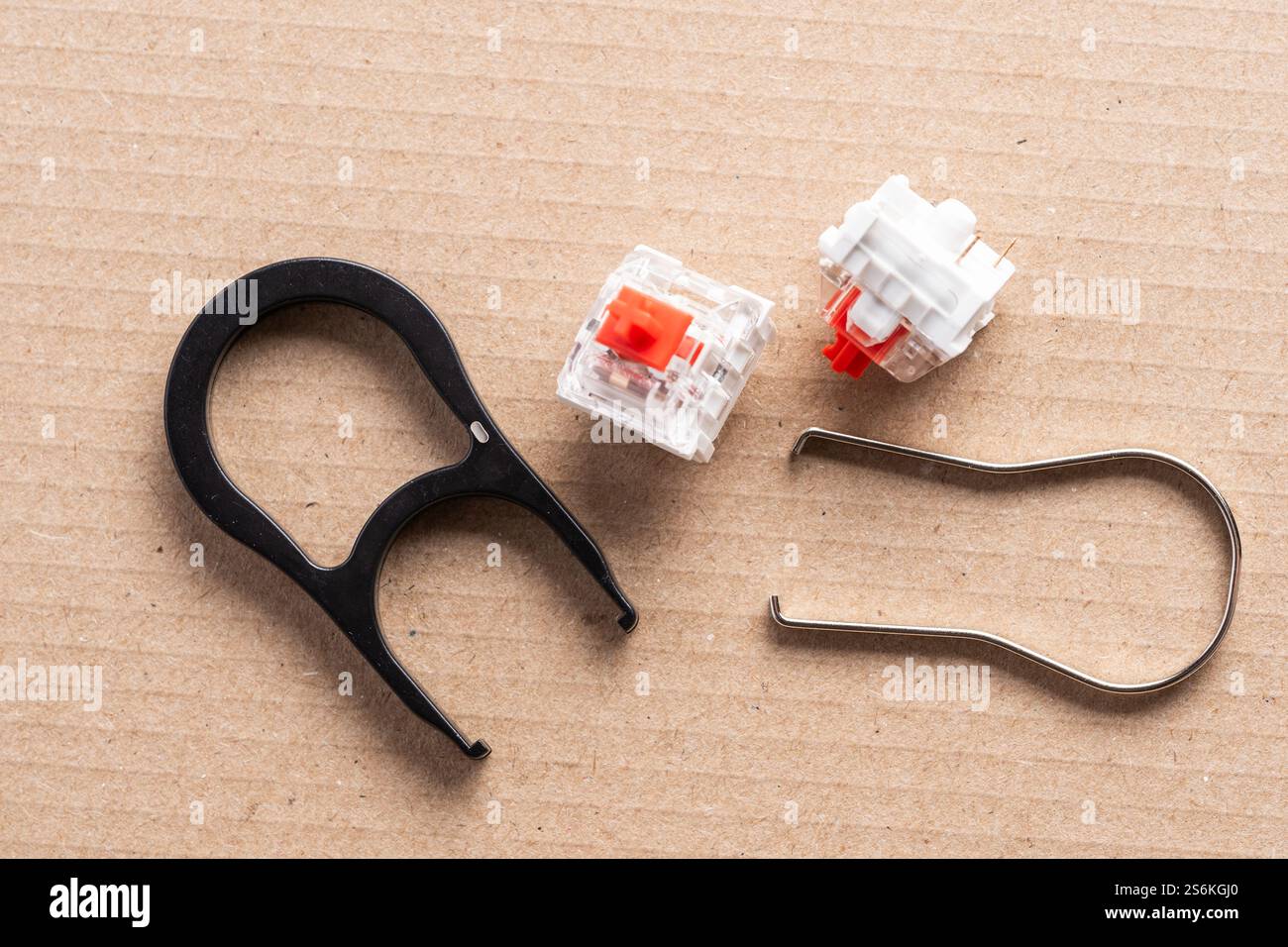 Mechanical keyboard repair components on cardboard background. View ...
