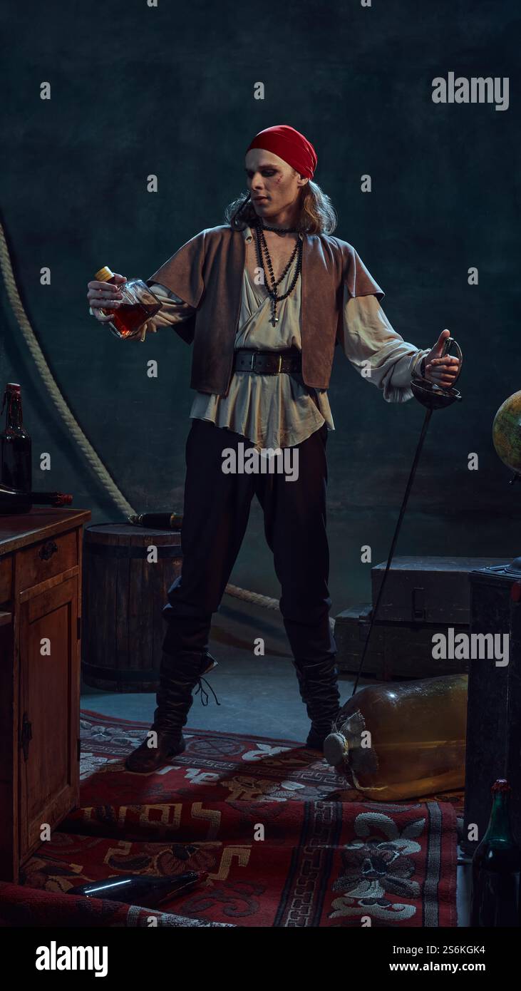 Full-length portrait of young man, pirate with wounded face in vintage ...