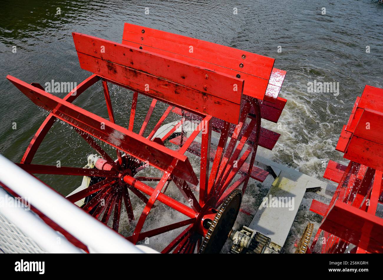 A paddleboats red paddles splashing through the water Stock Photo - Alamy